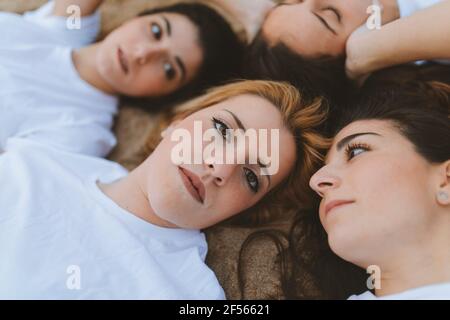 female friends lying on the sand on the beach Stock Photo - Alamy