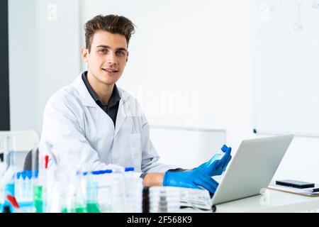 Male scientist using laptop in laboratory Stock Photo - Alamy