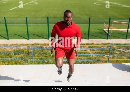 Athletic man running up steps Stock Photo - Alamy