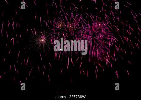 Full moon surrounded by pink and purple fireworks Stock Photo - Alamy