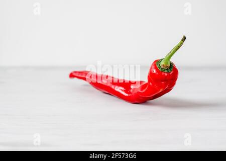 An Organic Red Romano Pepper against a plain background Stock Photo - Alamy
