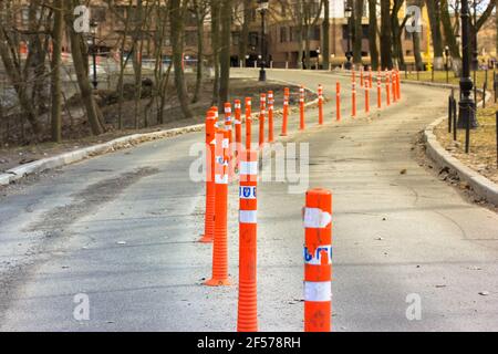 A line of flexible safety PVC delineators, orange plastic road poles ...