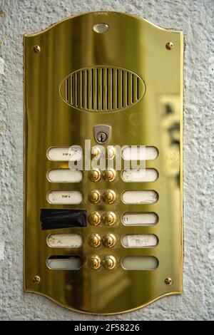 Brass bell push and names of apartment residents Stock Photo - Alamy
