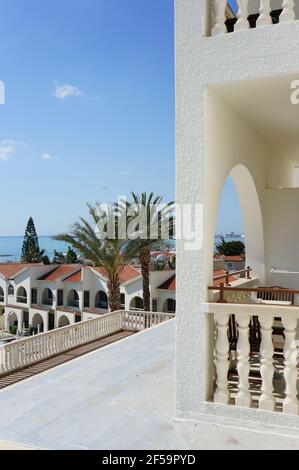 LARNAKA, CYPRUS - Mar 14, 2017: Two women sitting on a barrier next to ...