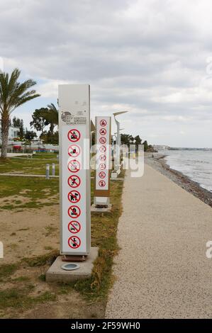 LARNAKA, CYPRUS - Mar 14, 2017: Two women sitting on a barrier next to ...