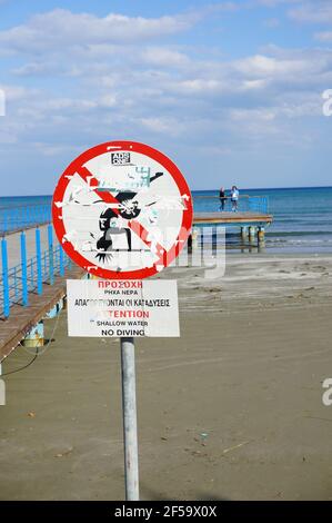 LARNAKA, CYPRUS - Mar 14, 2017: Two women sitting on a barrier next to ...
