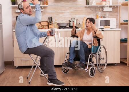 Disabled woman in wheelchair screaming and crying in front of couple ...