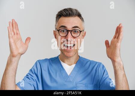 Excited white-haired medical doctor exclaiming and looking at camera ...