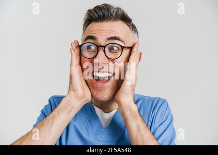 Excited white-haired medical doctor exclaiming and looking at camera ...