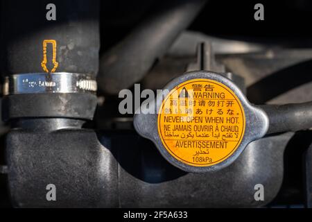 Warning sign of a car engine, orange engine sign on a panel of car ...