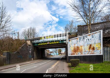 Low bridge warning sign with weathered billboard in Crewe Cheshire UK ...
