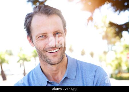 Handsome middle age man smiling looking at the camera at home Stock ...