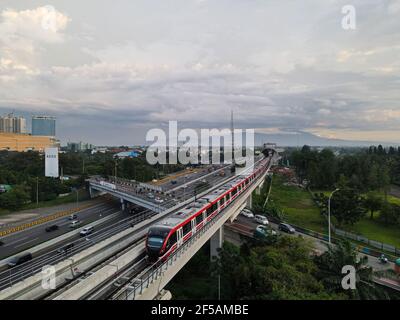 Aerial view of LRT train moving from station on the elevated tracks ...