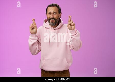 Nervous unsure hopeful handsome bearded 40s man in pink stylish hoodie ...
