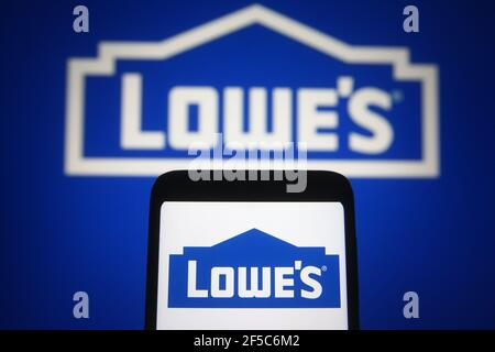 In this photo illustration, the Lowe`s Company logo is seen displayed ...