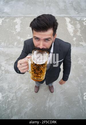 Full length, wide angle. Funny man drinking beer from a glass mug Stock ...