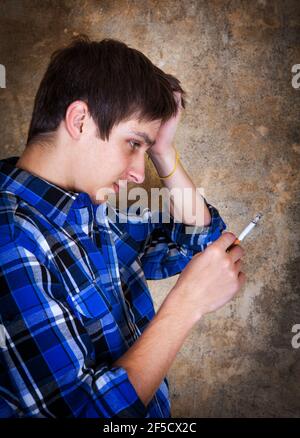 Sad Young Man smoking Cigarette on the Nature Background closeup Stock ...