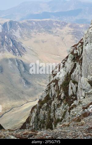 A rocky chasm; cliffs and crags in a steep valley descending ...