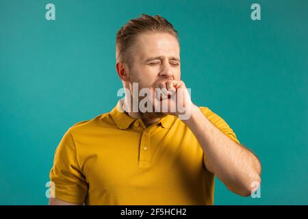 Tired sleepy man yawns. Lazy guy with long hairdo showing emotion of ...
