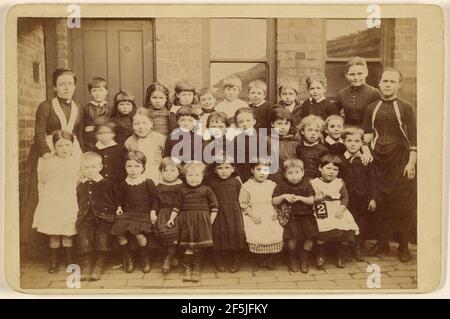 Large group of school children with teachers, all standing. Unknown ...