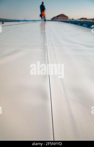 Construction site, application of a bituminous coating on a concrete ceiling, preparation for ...