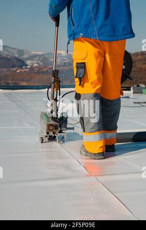Construction site, application of a bituminous coating on a concrete ceiling, preparation for ...