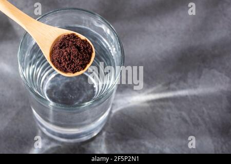 Euterpe oleracea - Spoon with organic acai powder and glass of filtered ...