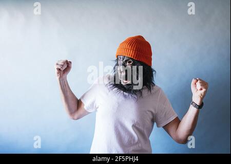 Male in a chimpanzee mask expressing happiness with his fists Stock ...