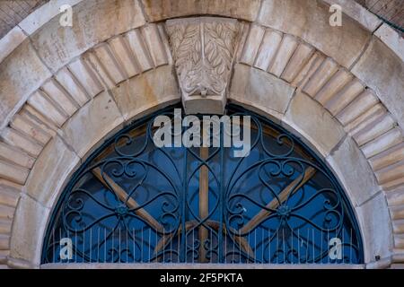 A stone lintel set in elaborately semi-circular upper window, with a ...