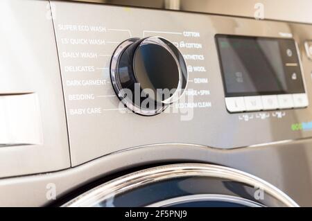Washing machine control programming panel with round dial and buttons ...