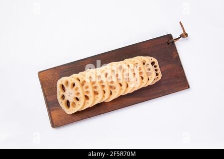 Top view of lotus root slices on the plate isolated on white background ...