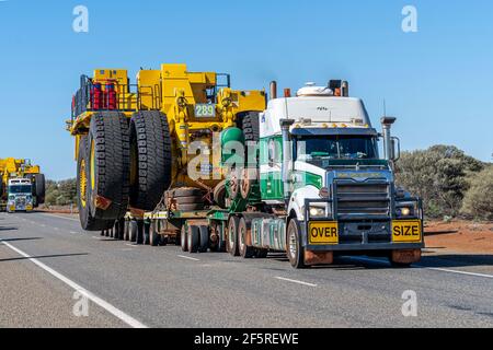 Heavy mine machinery being transported by road train trucks, Pilbara ...