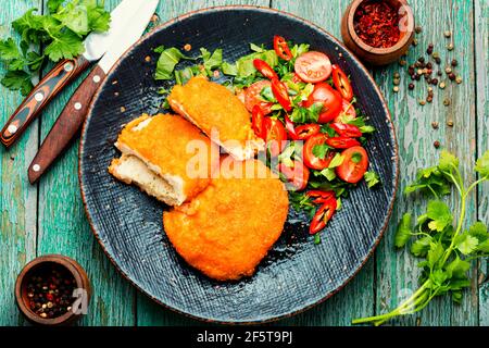 Chicken Kiev cutlet with fresh vegetable salad.Ukrainian food Stock ...