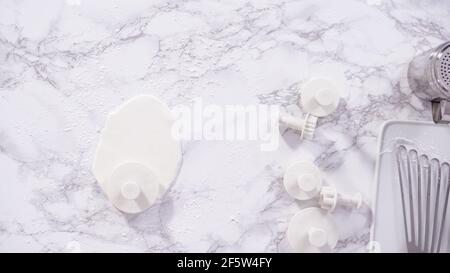 Flat lay. Step by step. Cutting out shapes from sugar cookie dough with ...