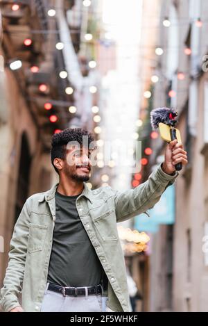 Young hispanic man streamer smiling confident holding headphones at ...