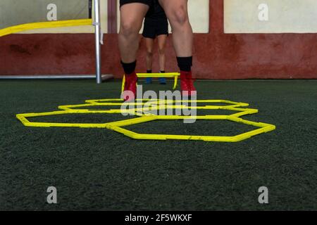 The football players on a hexagonal speed and agility training ladder ...