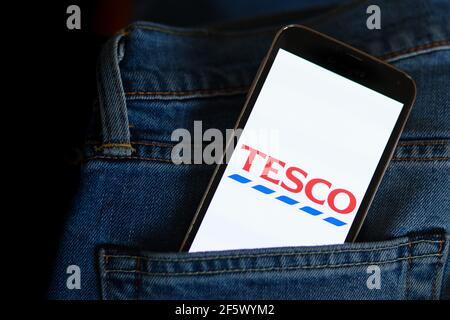 In this photo illustration, the Tesco logo is displayed on a smartphone ...