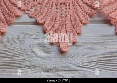 knitted lace. The material is folded randomly on a horizontal surface ...