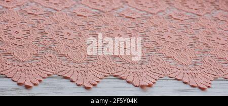 knitted lace. The material is folded randomly on a horizontal surface ...