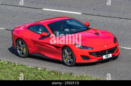 Red Ferrari Portofino supercar driven on a highway in central ...