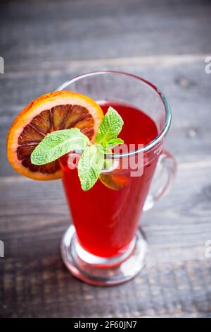 Fruit drink based on raspberry with red orange slice. Selective focus ...