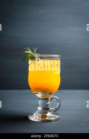 Hot buckthorn beverage in glass teapot. Selective focus. Shallow depth ...