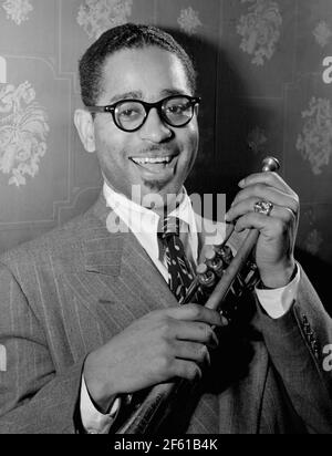 American jazz musician Dizzy Gillespie puffing out his cheeks during a ...