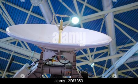 White rotating satellite dish antenna using to receive or transmit ...