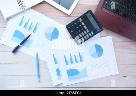 financial graph, calculator and notepad on table Stock Photo - Alamy
