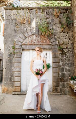 Beautiful girl at an old building with flowers Stock Photo - Alamy
