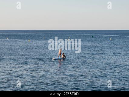 people paddle surfing on the costa brava in girona on a summer day in a ...