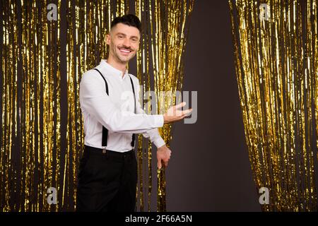 Photo of hospitable guy hand show empty space invitation wear green ...