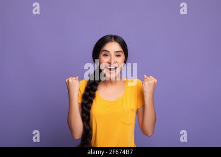 Yes. Portrait of emotional indian woman screaming with raised fists ...