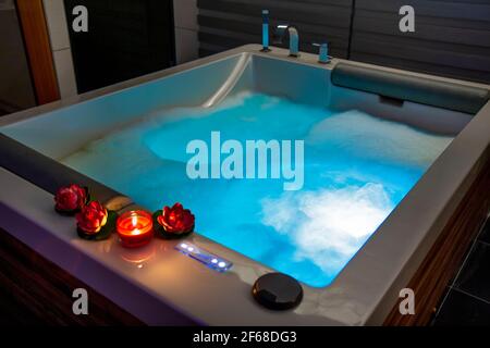 Hot tub with candles and water lilies Stock Photo - Alamy